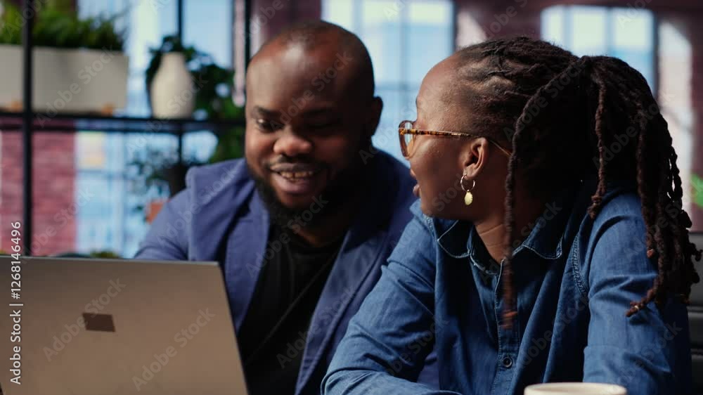 Black man and woman creating a report with online data from archived ... Black man and woman creating a report with online data from archived ...