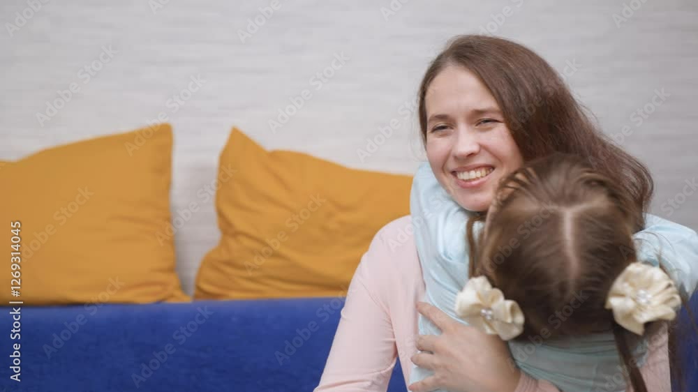 Mom smiles hugs, loves an adopted child, daughter. Happy family, daughter hugs mom. Family ...
