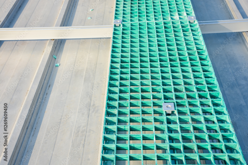Poster a green fiberglass grating panel installed on a metal framework ...