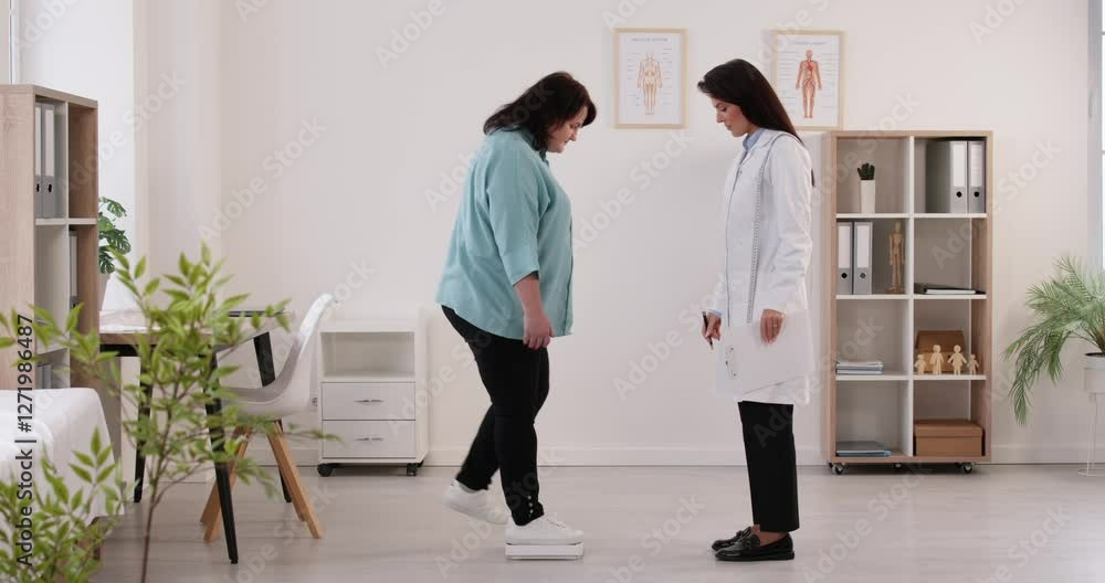 Process of weighing chubby woman on floor scale in presence of ...
