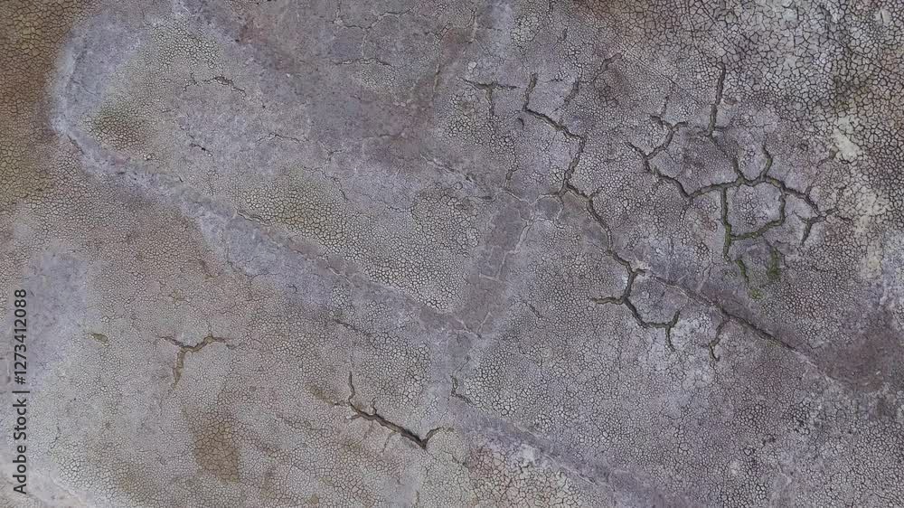 Dry and cracked gray soil ground during drought, viewed from above. top ...