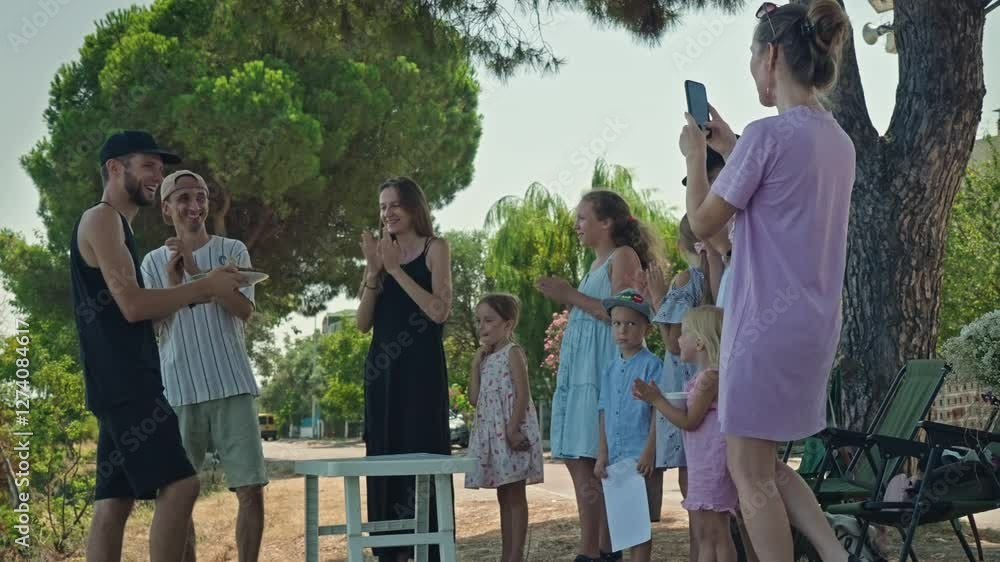 Birthday party, family outside on a summer day with kids and happy ...