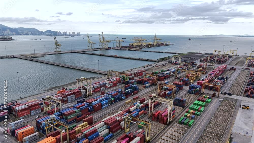 A busy freight shipping port in Southeast Asia with stacks of shipping ...