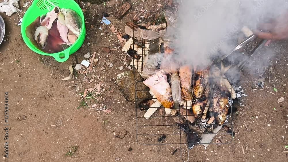 Burn stingrays and pelagic fish outdoors on the ground with coconut ...