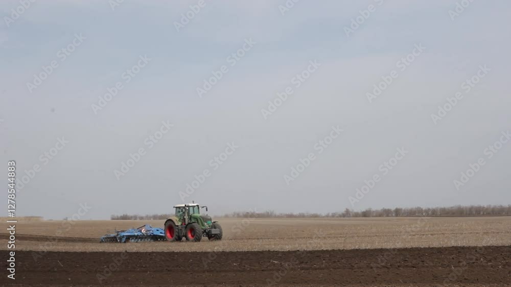 A powerful tractor plowing vast Vojvodina plains, turning rich soil ...