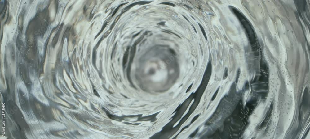 Water vortex swirling counterclockwise in slow-motion. The water is ...