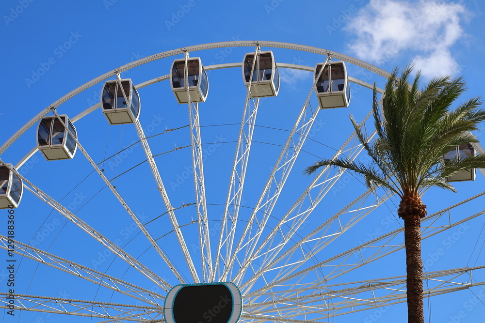 Poster Beautiful fair wheel with metal structure and cabin for people ...
