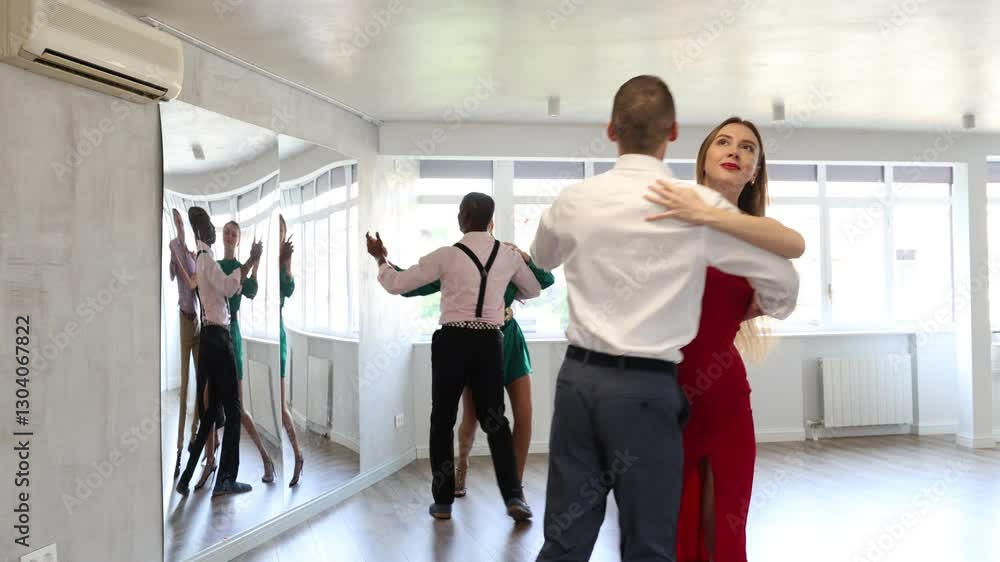 Energy man and young woman are dancing classic version of waltz in ...