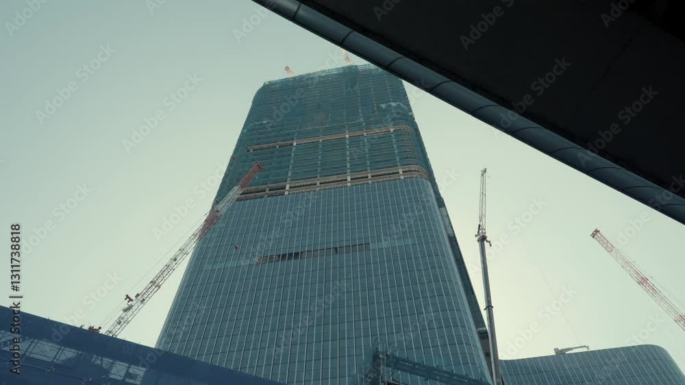 Ground-up view of a skyscraper under construction in Tokyo, featuring ...