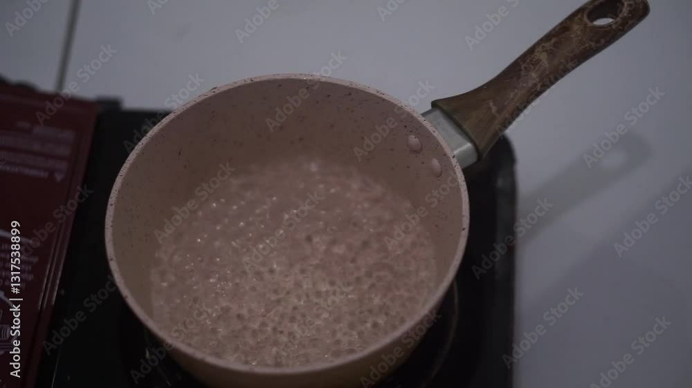 Steam and hot water bubbles emerge from the boiling hot water. Boil hot ...