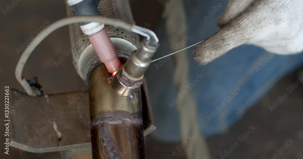 Technician is welding pipe to add position of o2 sensor.Car pipe ...