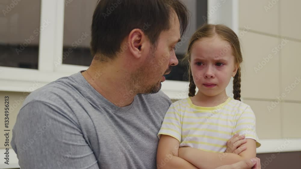 Caring father comforting his crying daughter, emotional moment between ...