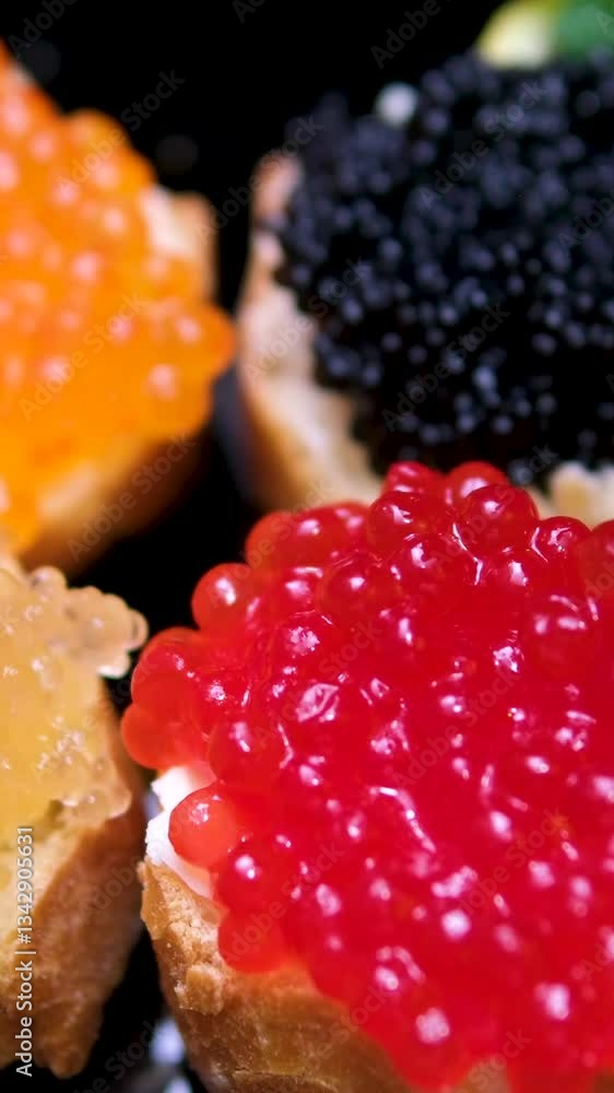 four types of caviar decorated banquet table with appetizers from ...
