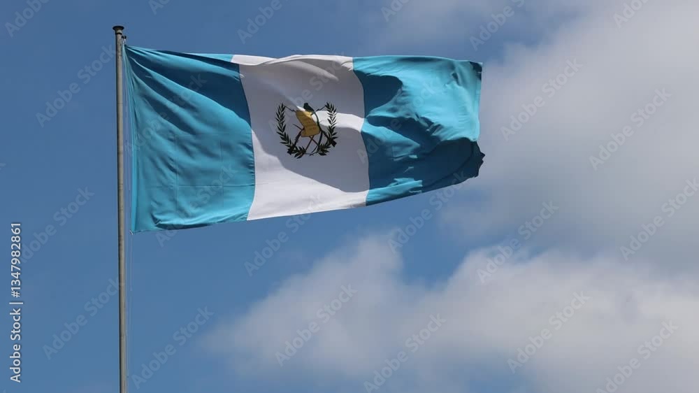 guatemala flag waving in the breeze above a historic colonial building ...