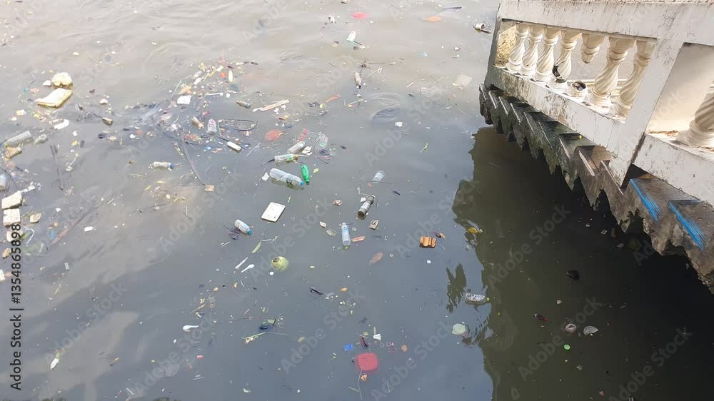 Garbage in the river, floating garbage causes water pollution. Garbage ...