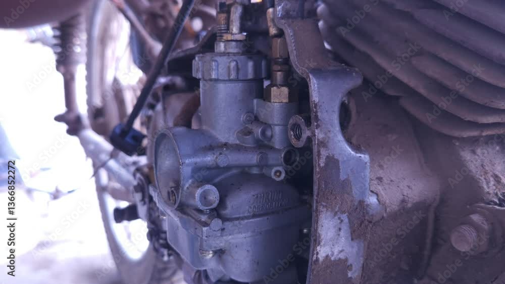 A Indian motorcycle mechanic works on a motorcycle. Adjusting and ...