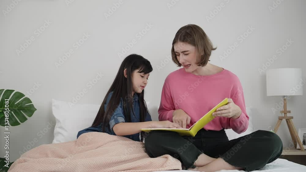 Caucasian mother reading story book to cute daughter listening story ...