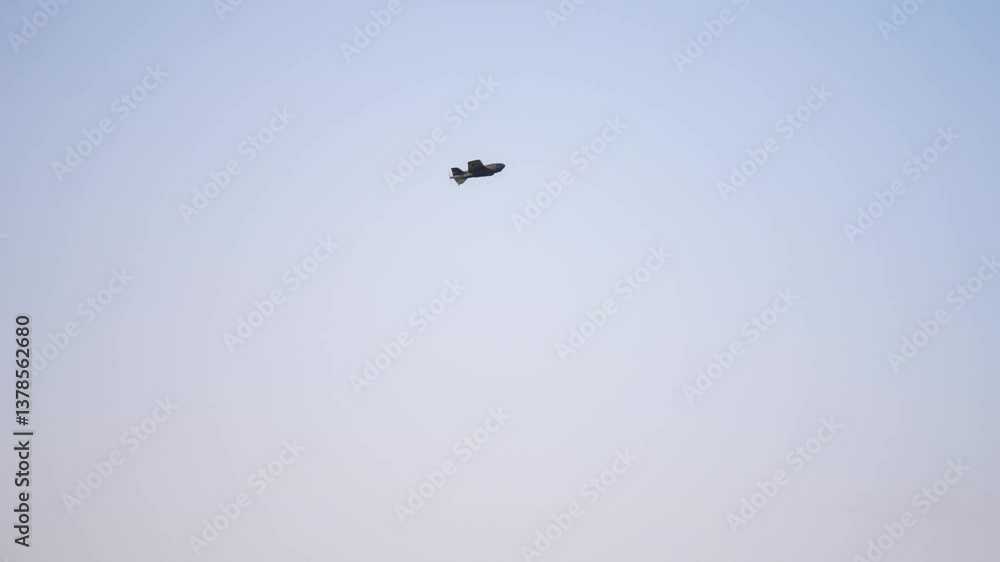 Military Drone Aircraft flying in blue sky. UAV in flight ...