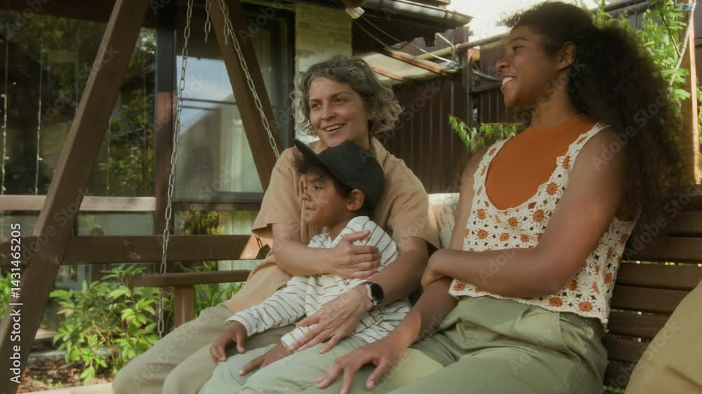 Medium full shot of cheerful mature Caucasian mom with biracial ...