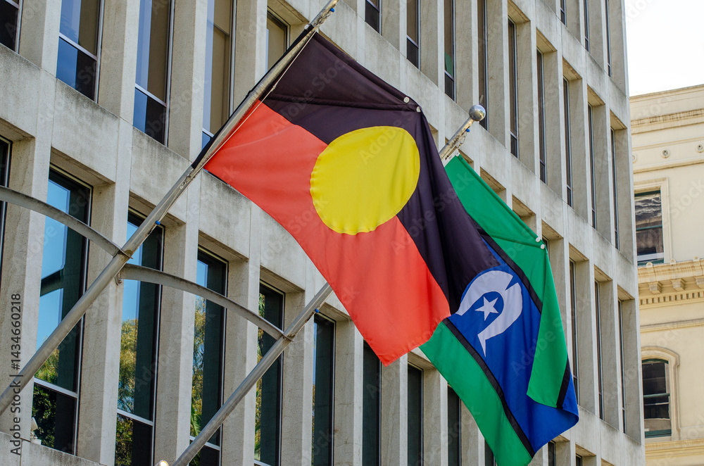 Plakat, Poster The Aboriginal flag and Torres Strait Islander flag fly together on an office ...