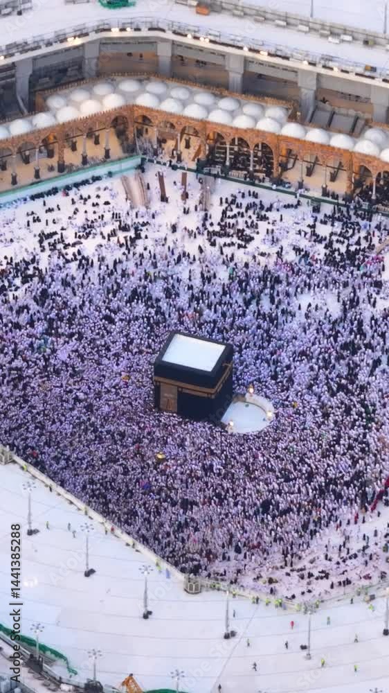 Dense aerial close-up showing thousands of pilgrims performing Tawaf ...