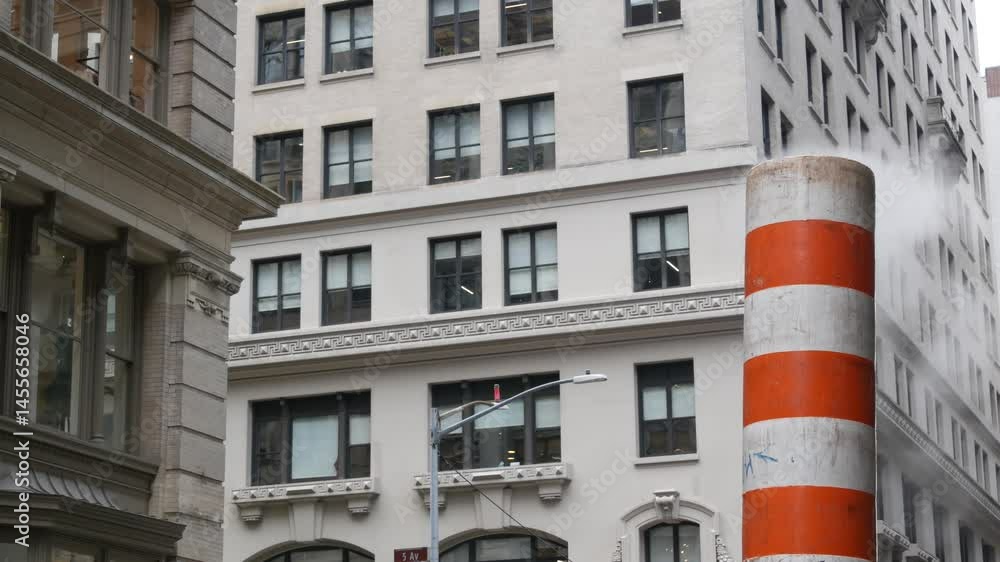 Steam vapor vented on New York City street, orange vapour tube stack ...