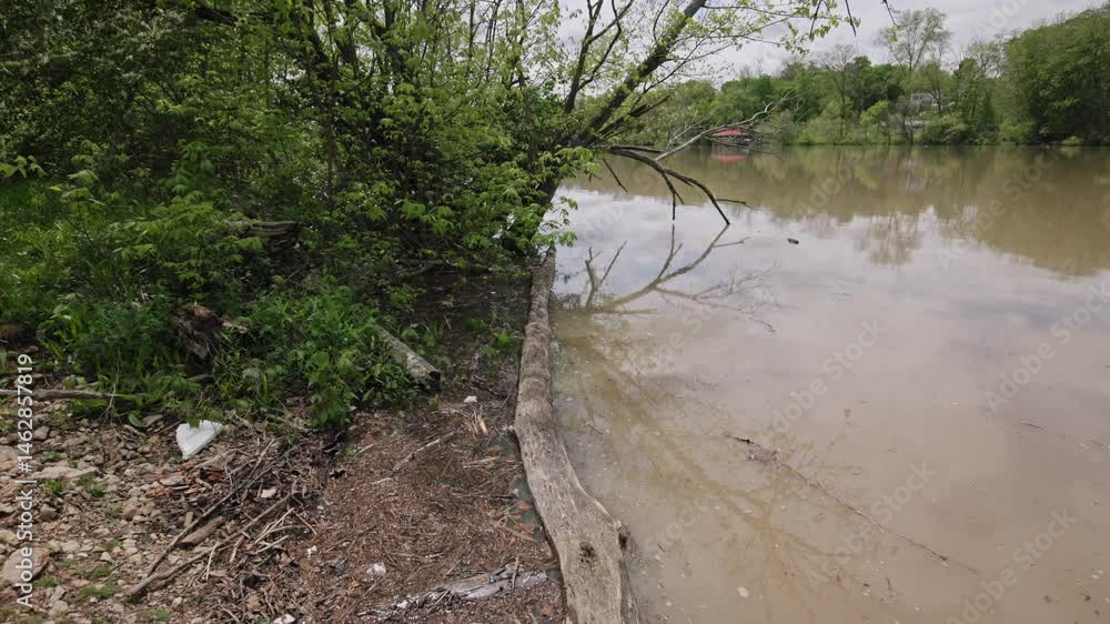 Water overflow on edge of river body and bed, flooding and overfilling ...