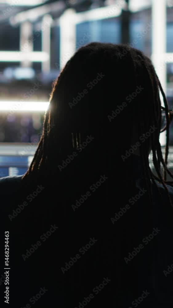 Vertical video Server room programmer interpreting AI generated data analytics graphs, putting ...