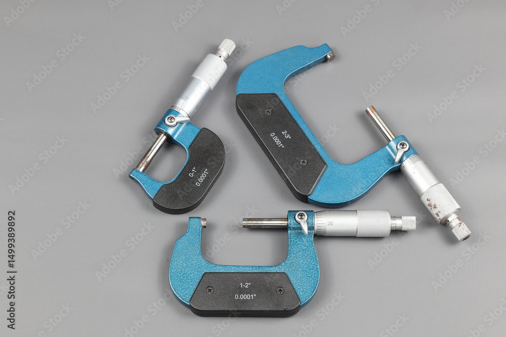 Poster Three blue micrometers with various sizes, a micrometer is a ...