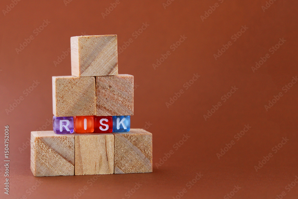 Poster Wooden blocks are supported by smaller ones that form the word ...