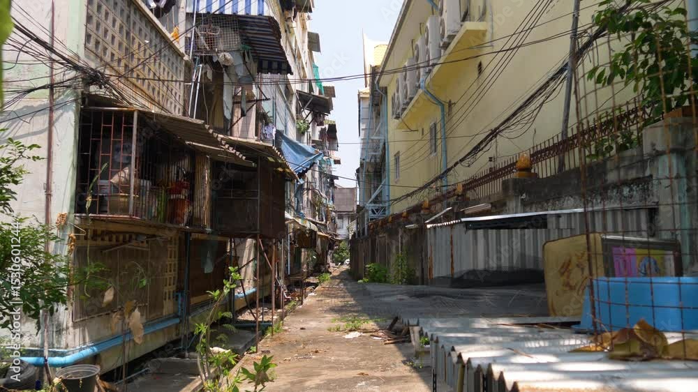 Narrow alley in Bangkok city, where lower-class residents live among ...