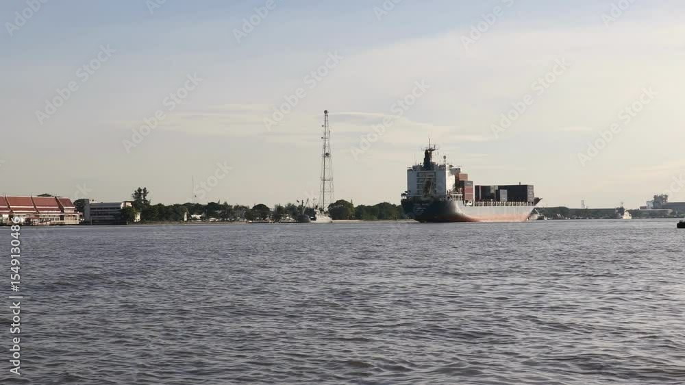 Large container ship at sea departing from wharf harbor port discharge ...