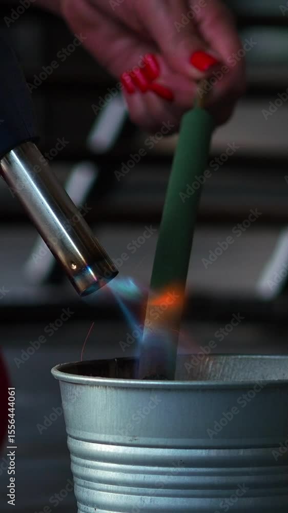 Ignite an insect stick with a gas cylinder. A smoking, smoldering stick ...