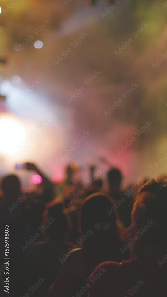 vertical shot. Passionate audience enjoying energetic rock show with ...