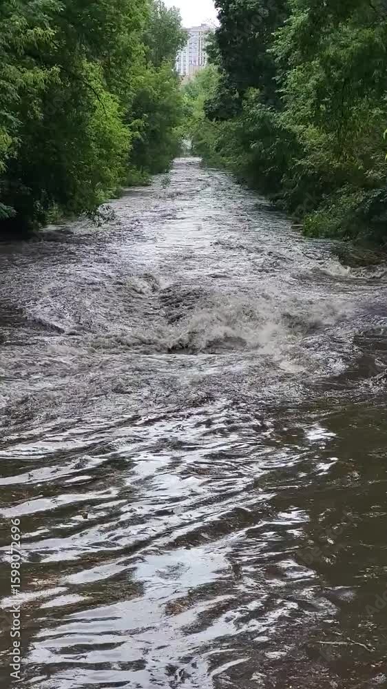 Flooded urban river serving as a stormwater drainage channel after ...