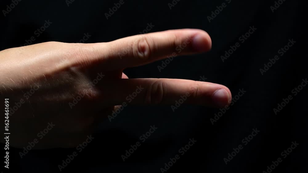 Gesture of scissors with hands on black isolated background close-up ...
