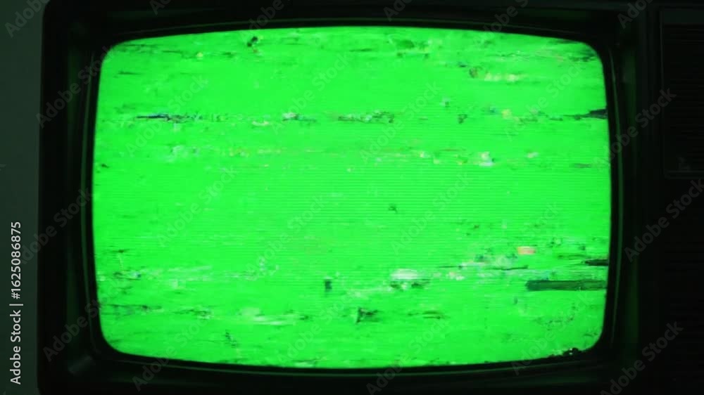 Retro CRT television with a flickering green screen displaying analog ...