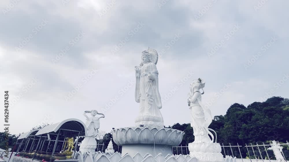 Guanyin Bodhisattva Statue Against Blue Sky Background. The statue of ...