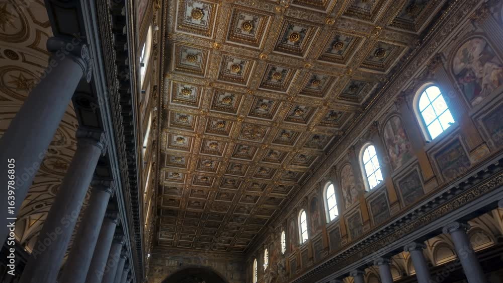 Golden coffered ceiling and tall windows of Basilica di Santa Maria Maggiore with classical ...