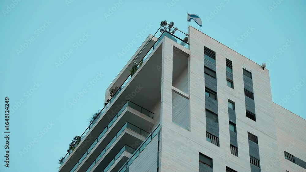 A part of a residential building, in a low angle telephoto view, where ...