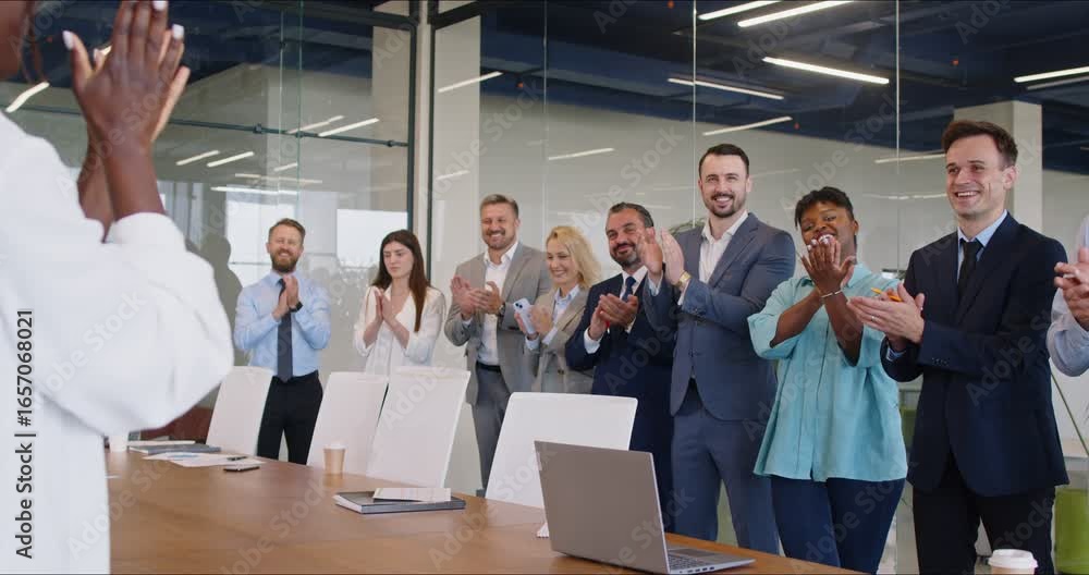 Young multicultural team giving a standing ovation in the boardroom. A ...
