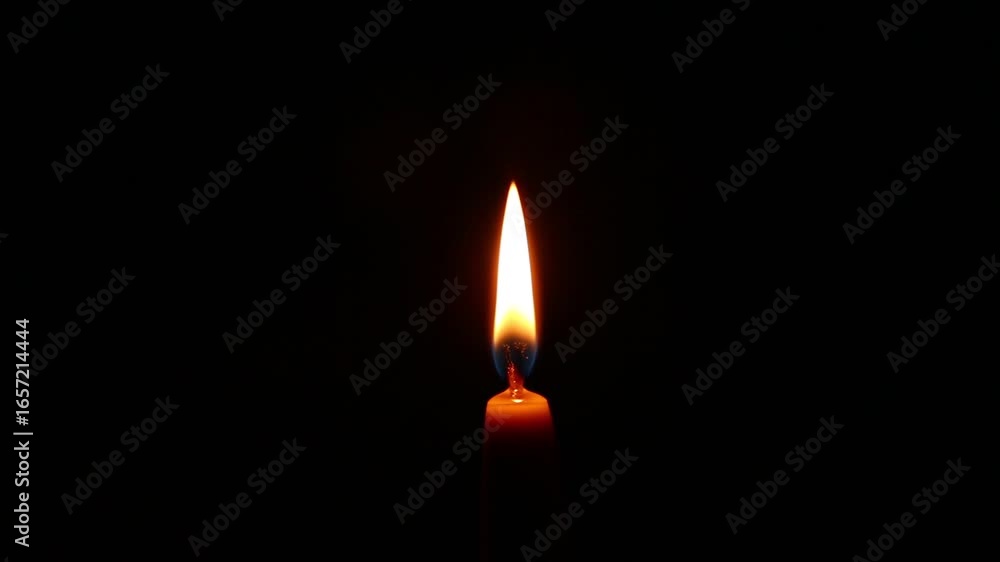 Burning candle flame and then person blowing out the candle on dark ...