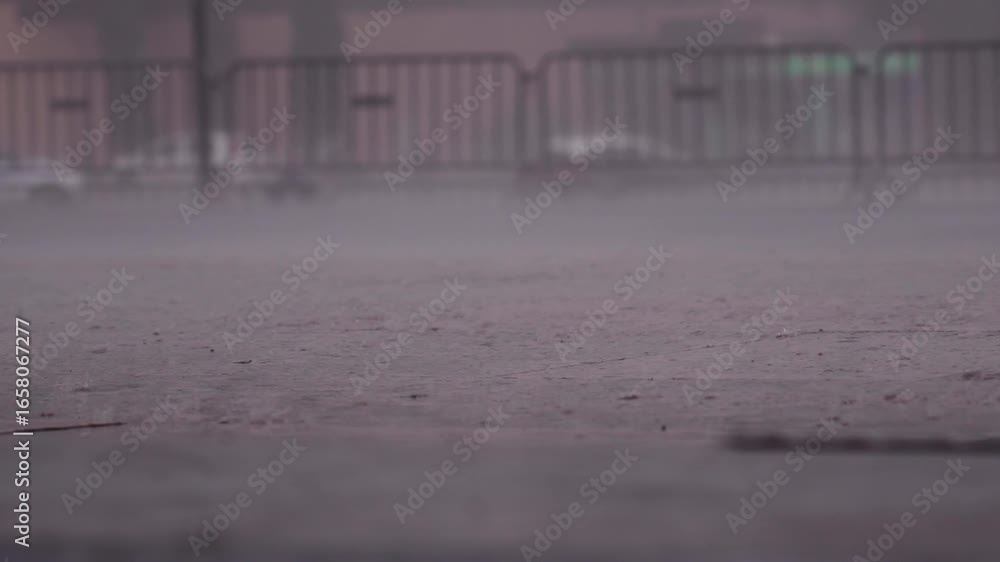 Low angle ground level view of rain-soaked cobblestone pavement during ...