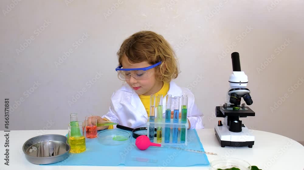 Laboratory examination of a child with test tubes, reagents and a ...