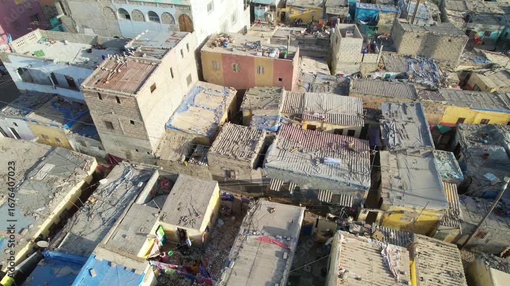 SENEGAL - 7.16.2025 - Strong aerial footage moving over rooftops in a ...