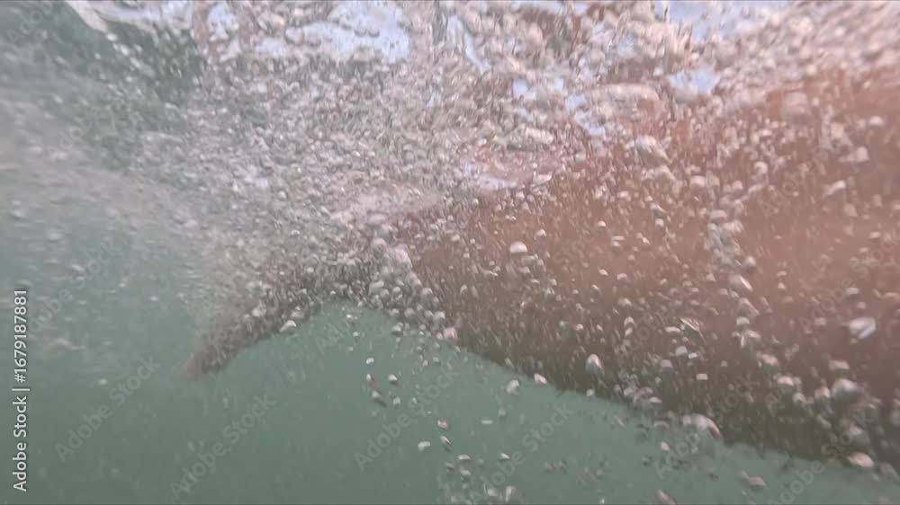 Underwater scene of drowning person with visible arm above surface and ...