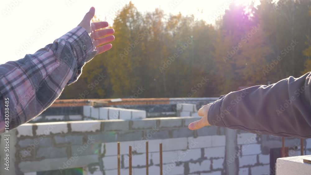 Construction workers discussing project details at building site ...