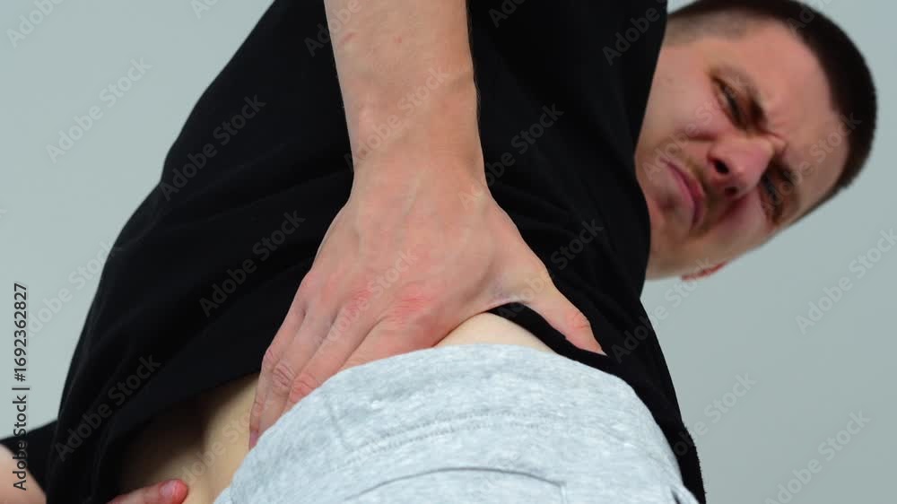 Hernia and back problems. Lower back pain after active sports. A person ...