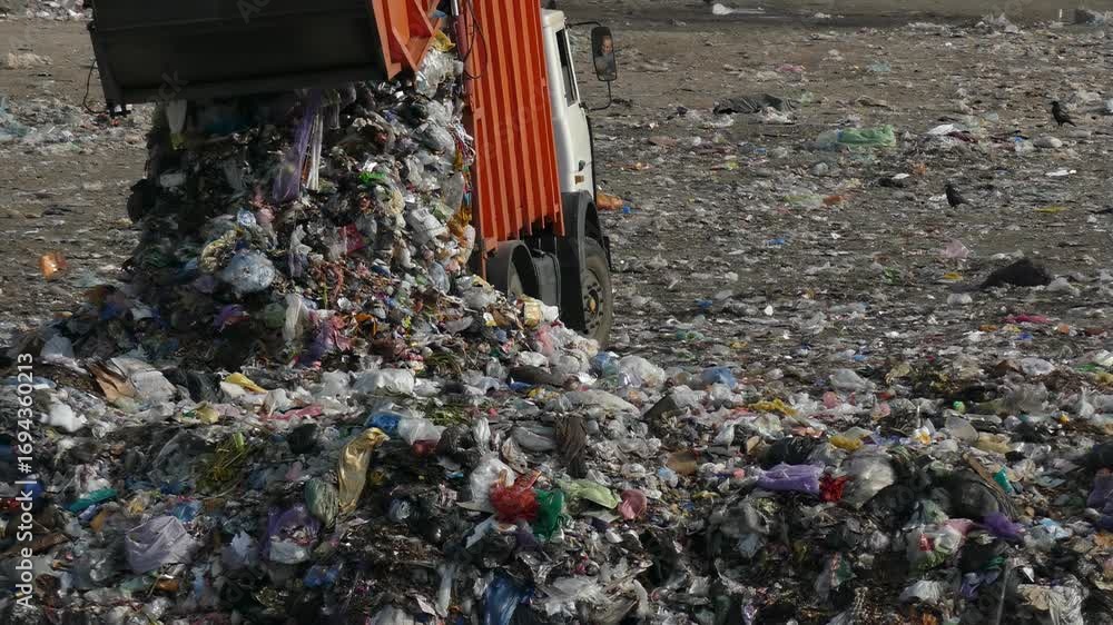 A large truck is dumping garbage. A lot of rubbish and plastic on the ...