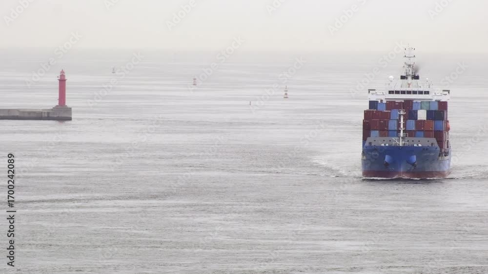 Front view of a blue container ship entering Osaka Port, Japan ...